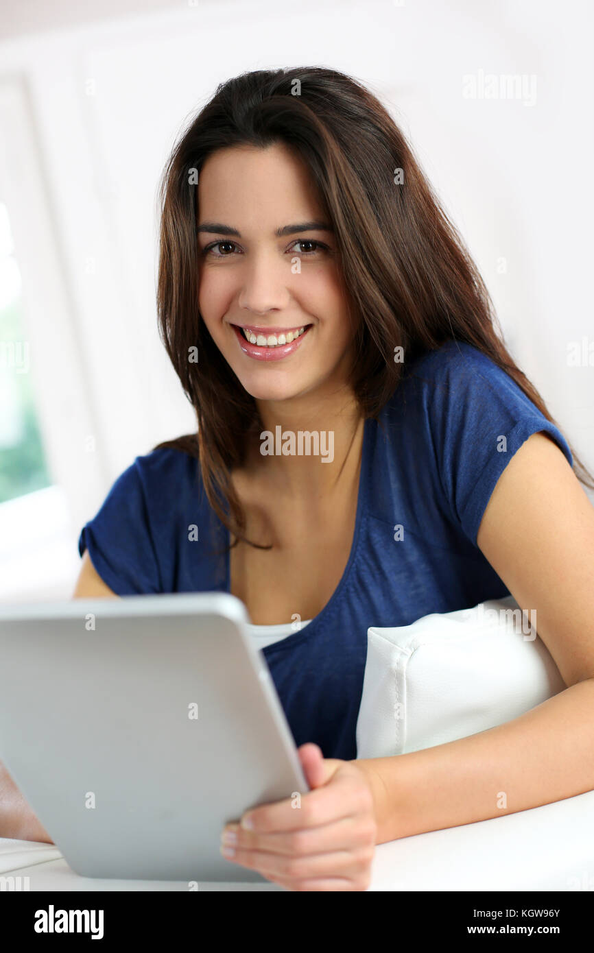 Smiling brunette girl using electronic tablet Stock Photo - Alamy