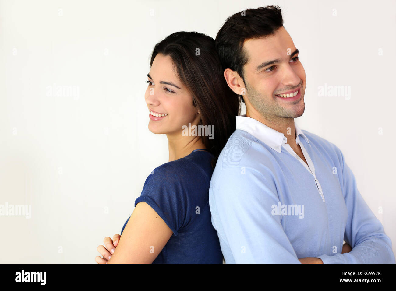 Young in love couple standing back to back Stock Photo - Alamy