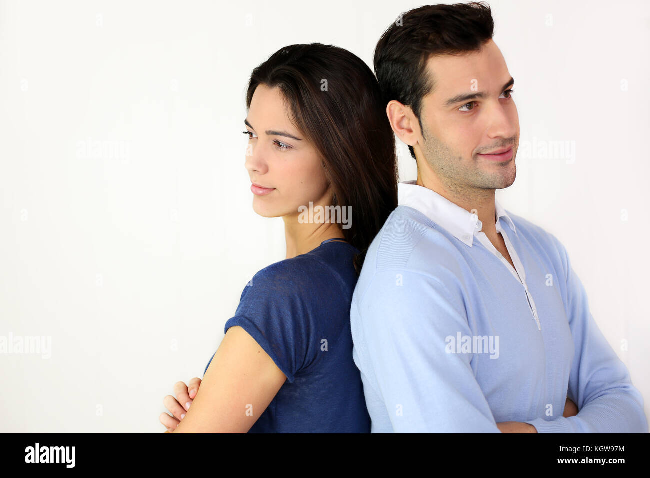 Young in love couple standing back to back Stock Photo - Alamy