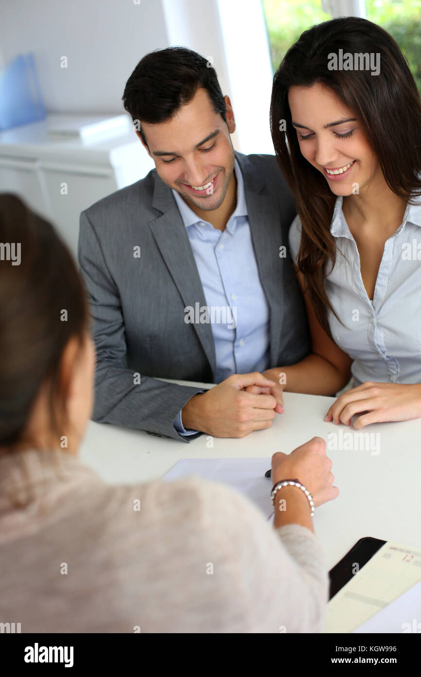 Young couple signing financial contract Stock Photo - Alamy