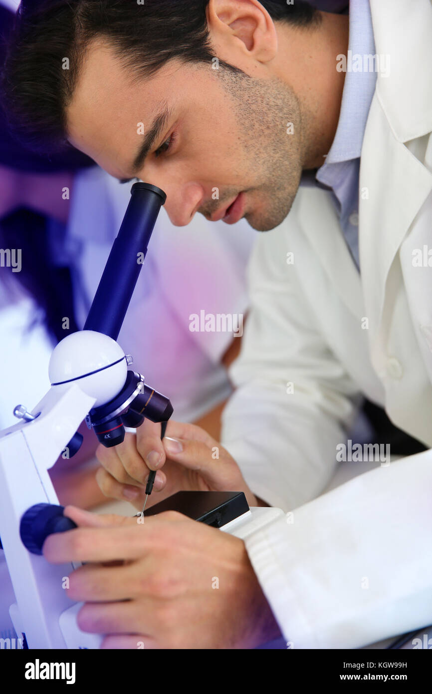 Doctor in biology working on microscope Stock Photo - Alamy