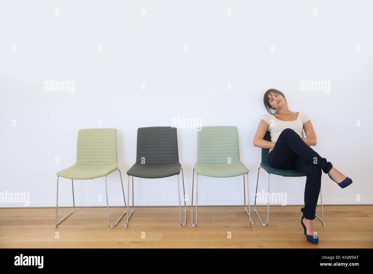 Young woman in waiting room falling asleep Stock Photo - Alamy
