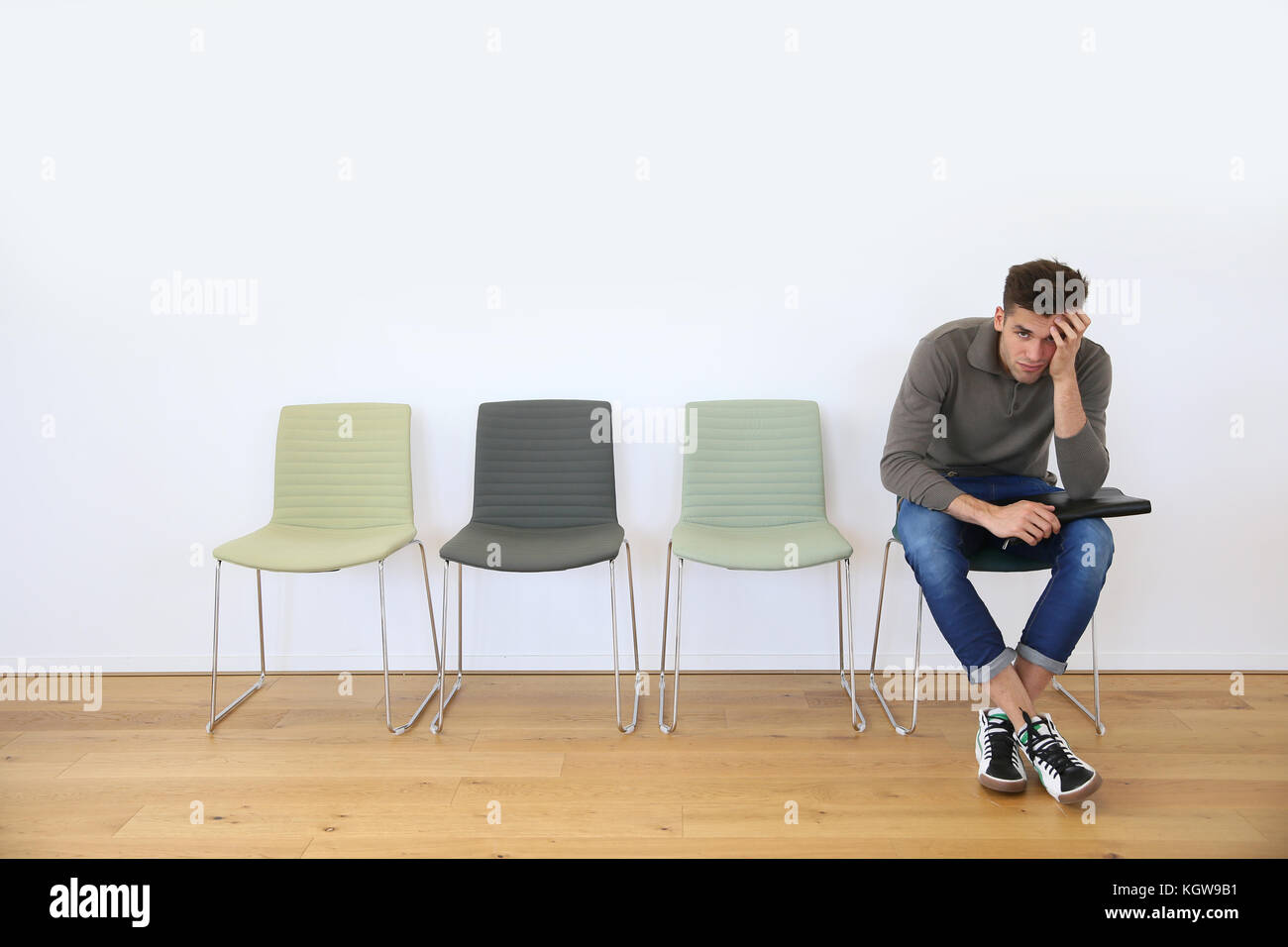 Young man in waiting room for job interview Stock Photo - Alamy
