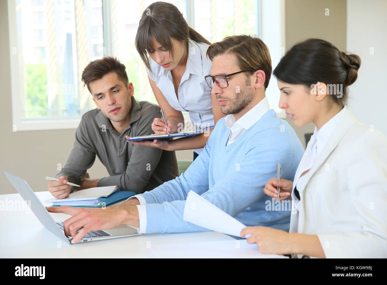 Group of business people working on laptop Stock Photo - Alamy