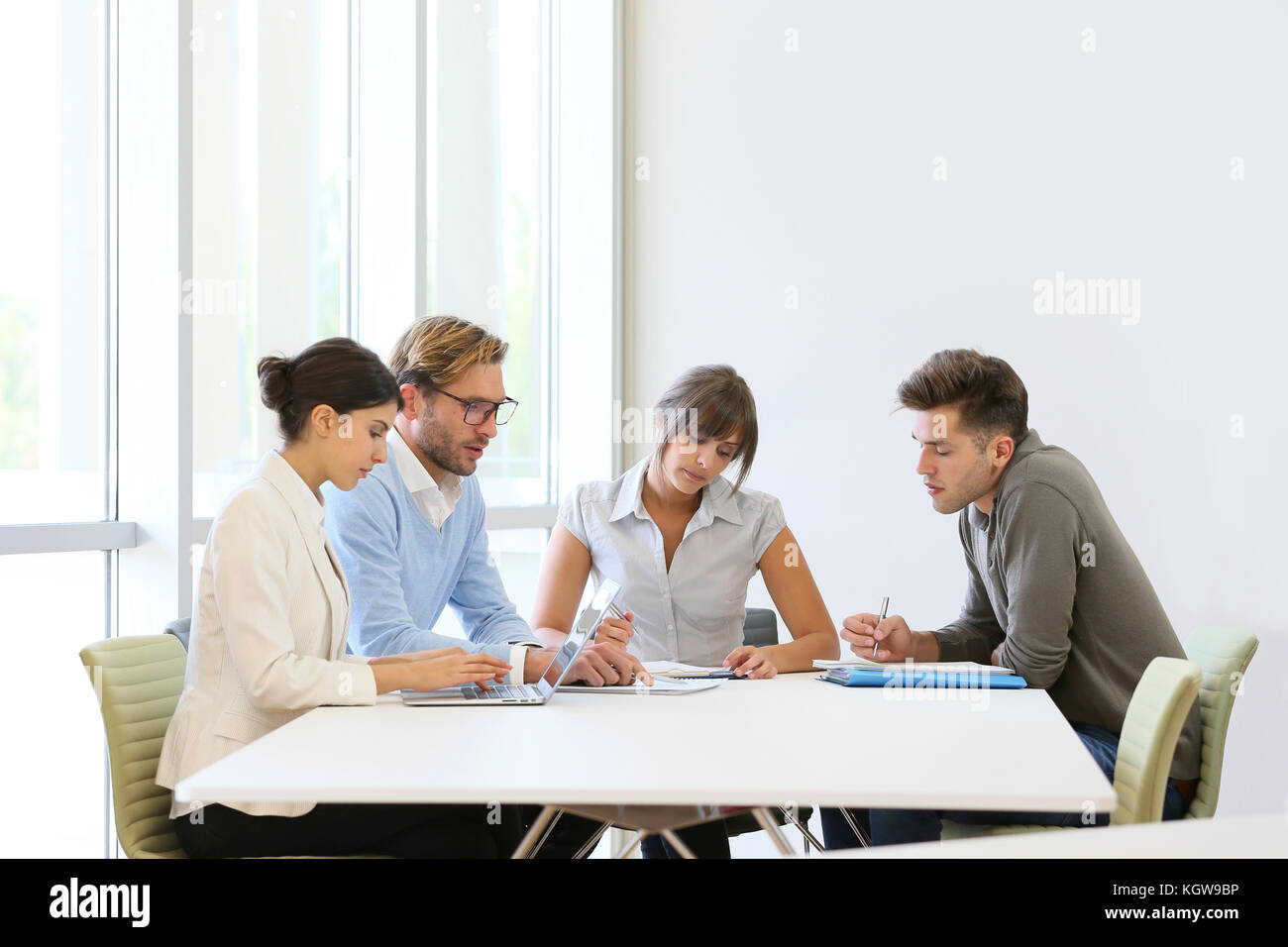 Business people meeting around table in modern space Stock Photo - Alamy