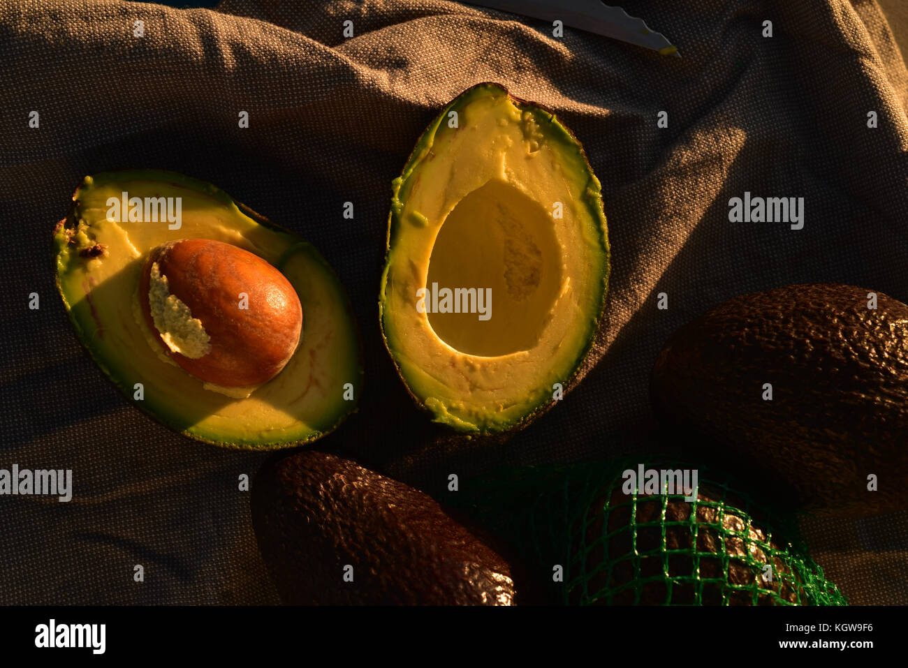 ripe avocado cut in half Stock Photo - Alamy