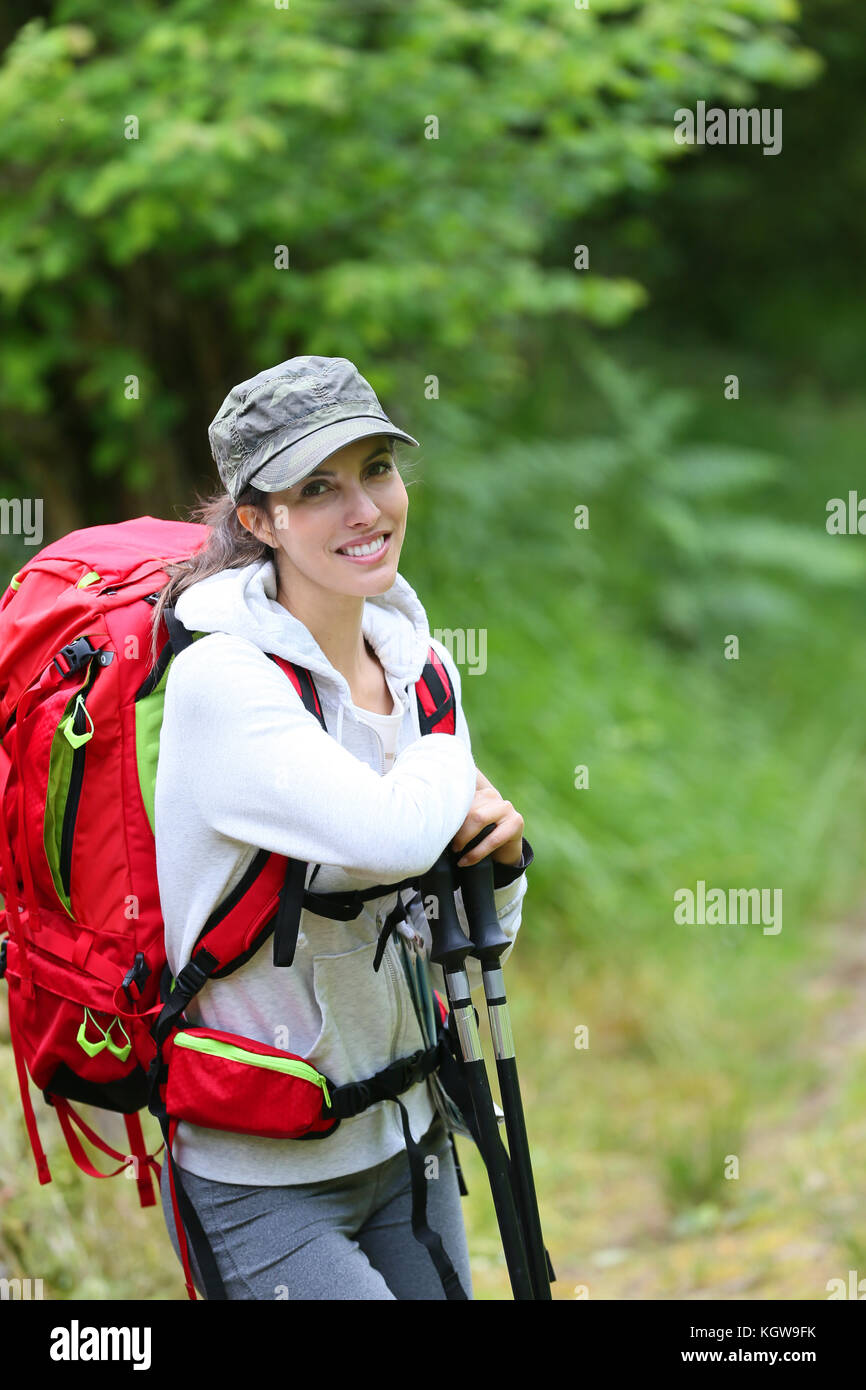 Portrait of cheerful backpacker in forest Stock Photo - Alamy