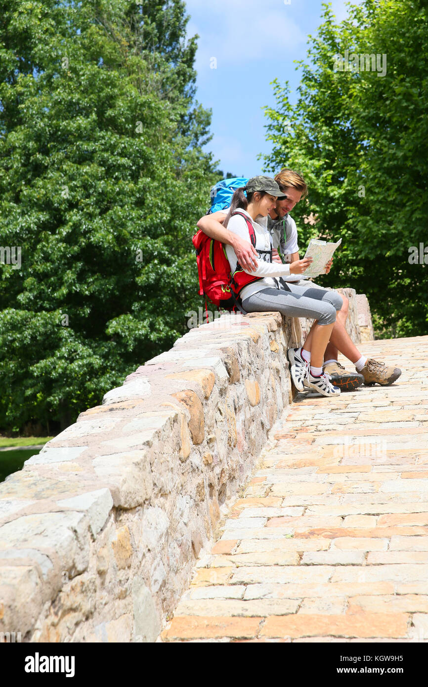 Woman hiking sitting bridge reading map hi-res stock photography and ...