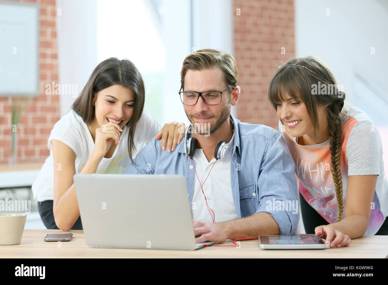 Group of friends connected together on laptop and tablet Stock Photo ...