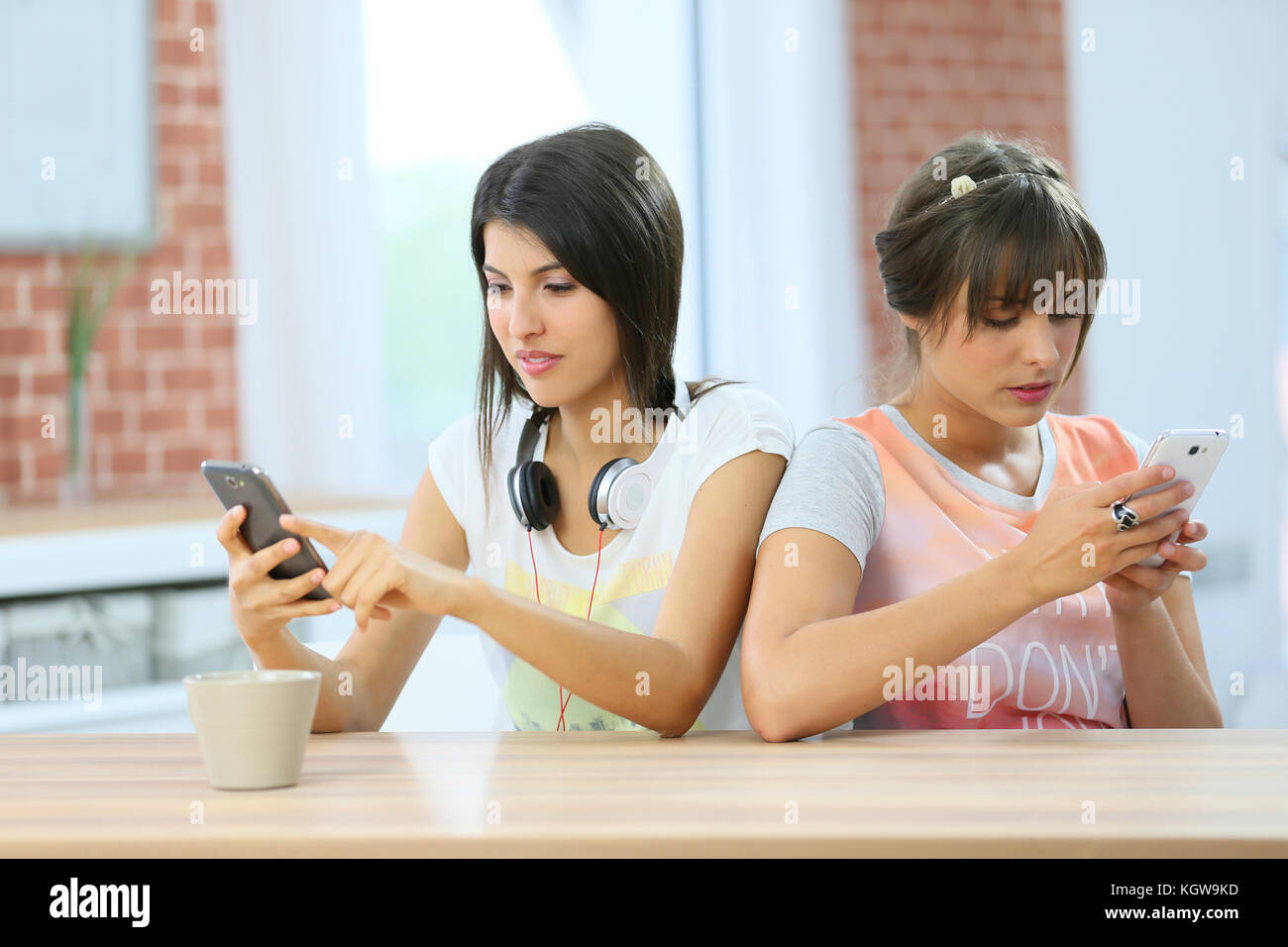 Girls playing with smartphones Stock Photo - Alamy