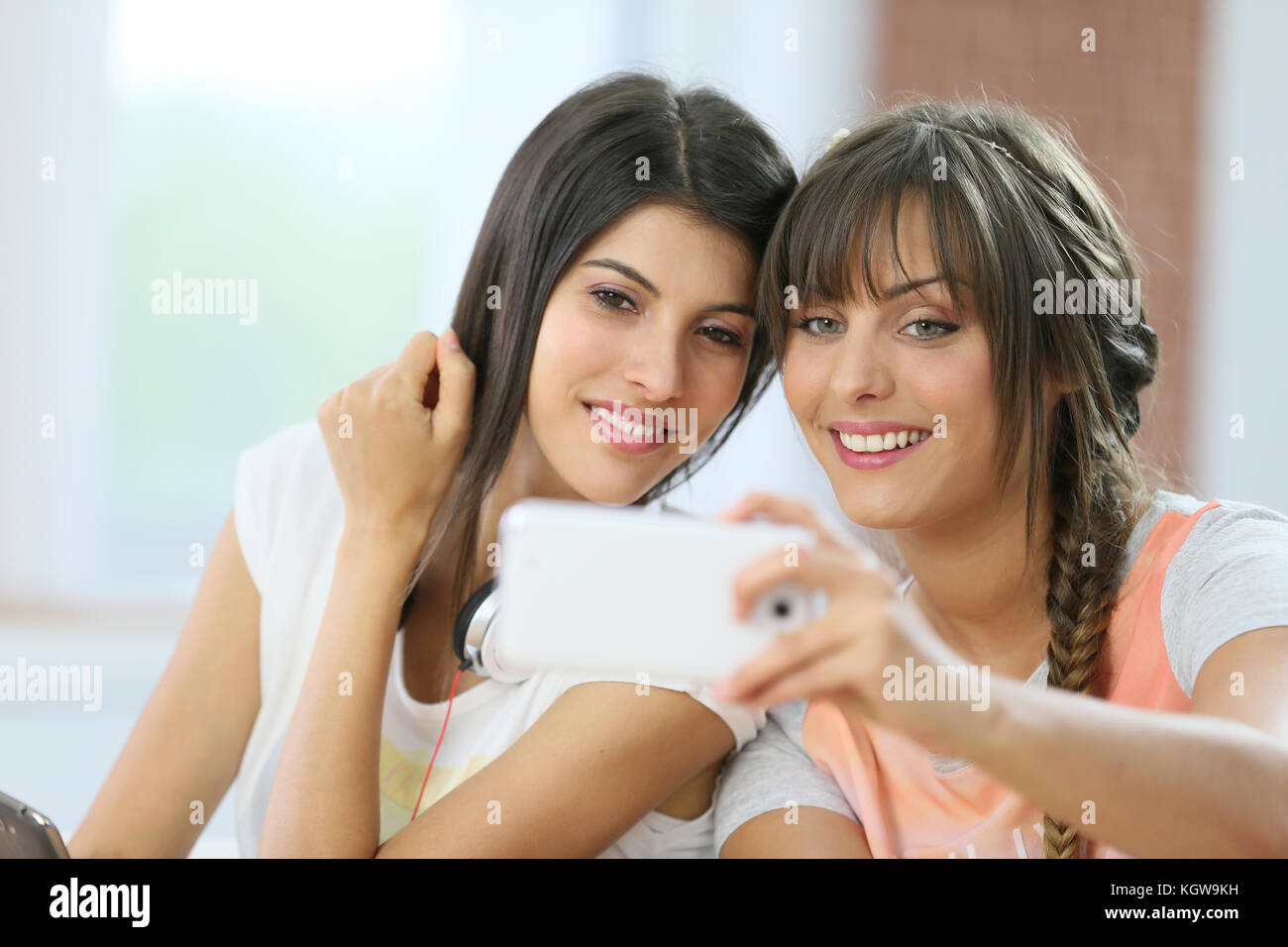 Girls playing with smartphones Stock Photo - Alamy