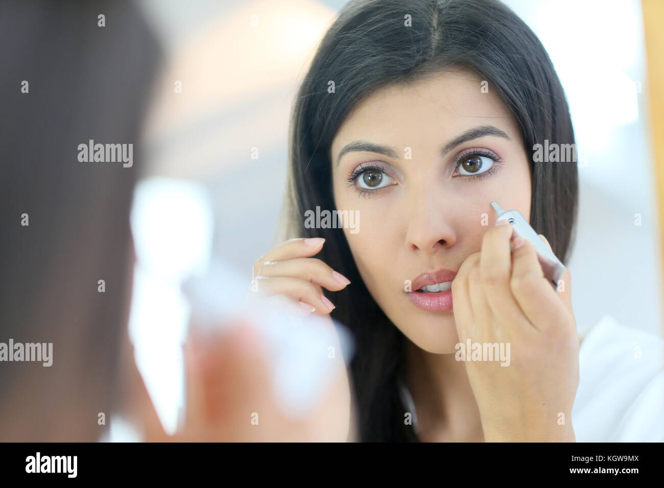 Portrait of beautiful woman using cosmetics Stock Photo - Alamy