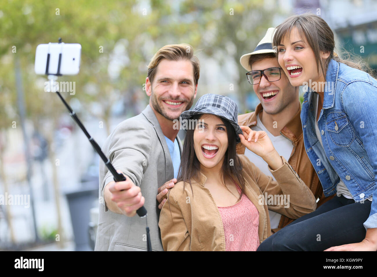 Group of friends taking picture of themselves with smartphone Stock ...
