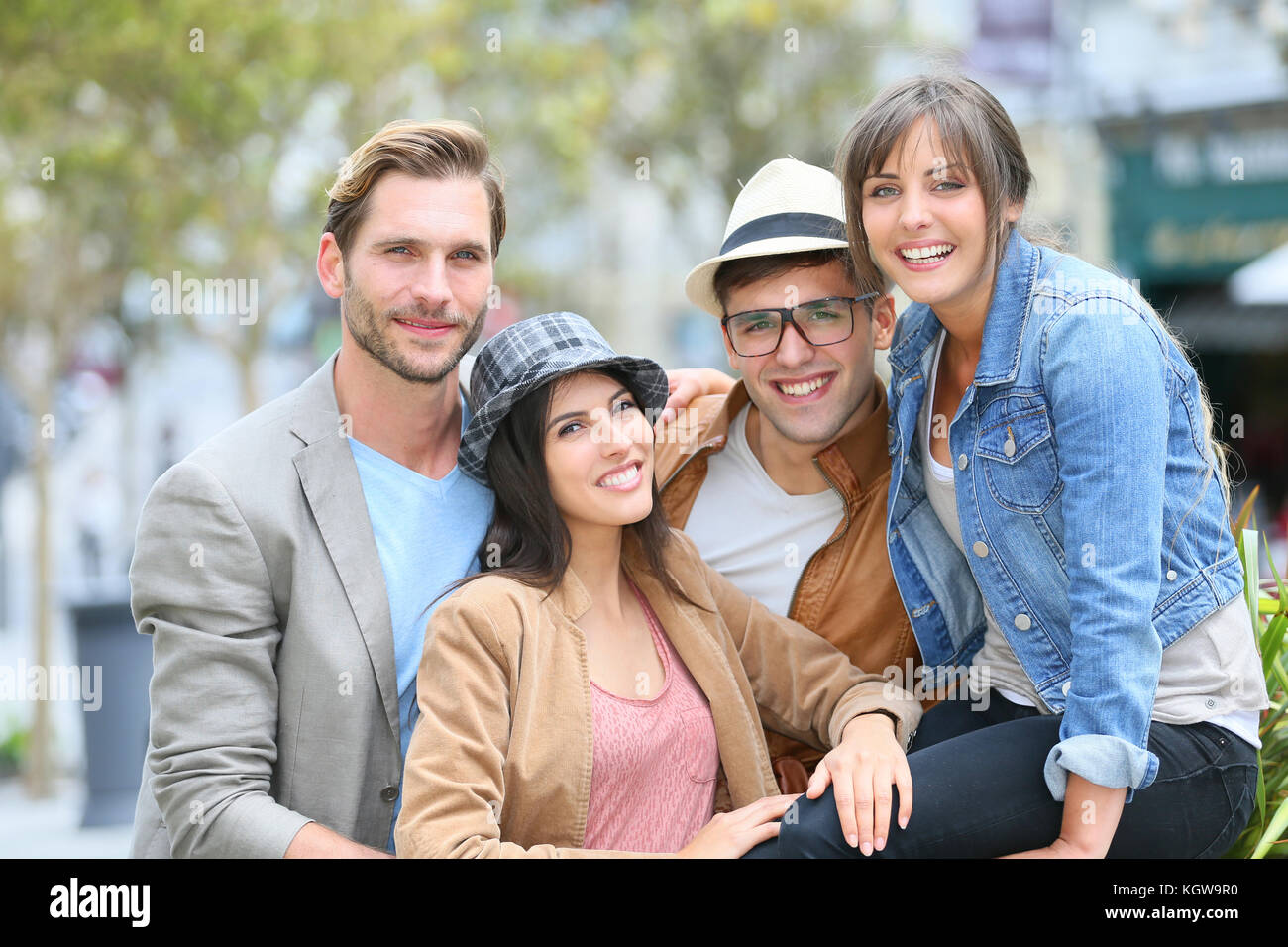Group of young people hanging out together in town Stock Photo - Alamy