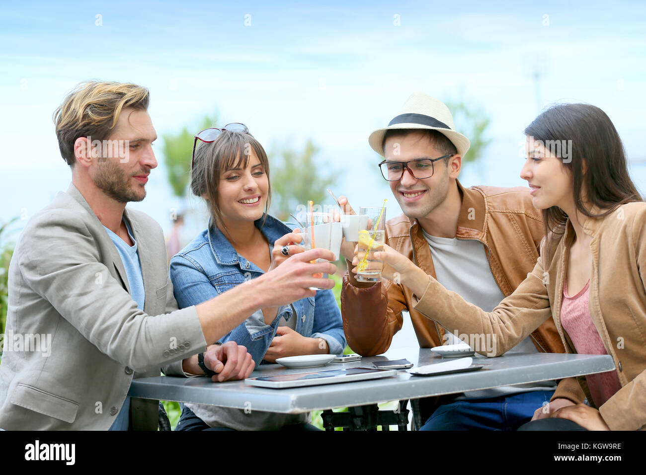 Group of friends cheering at restaurant terrace Stock Photo - Alamy