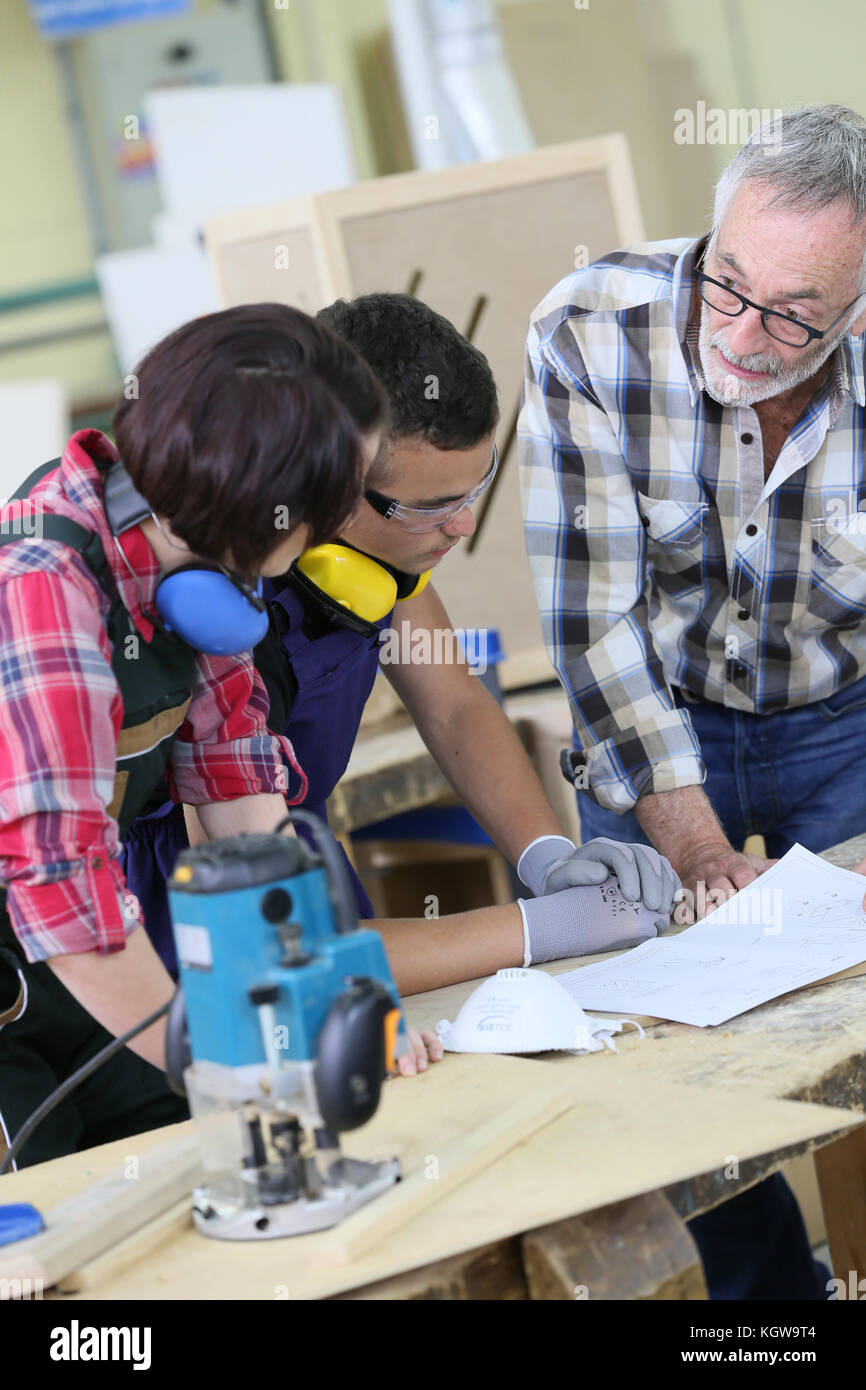 Young people in carpentry course with teacher Stock Photo - Alamy