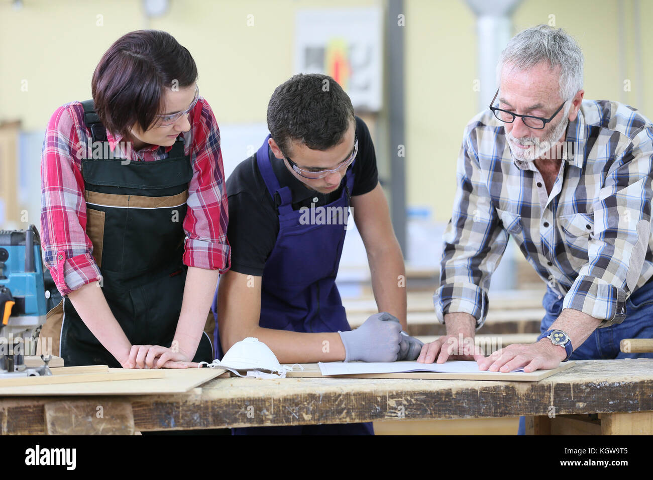 Young people in carpentry course with teacher Stock Photo - Alamy
