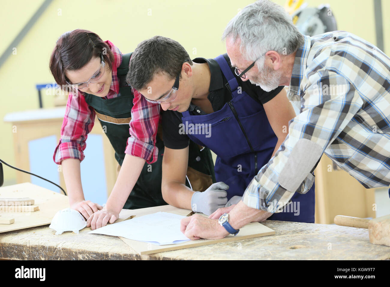 Young people in carpentry course with teacher Stock Photo - Alamy