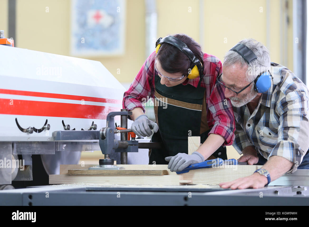 Young trainee in carpentry using sawing machine Stock Photo - Alamy