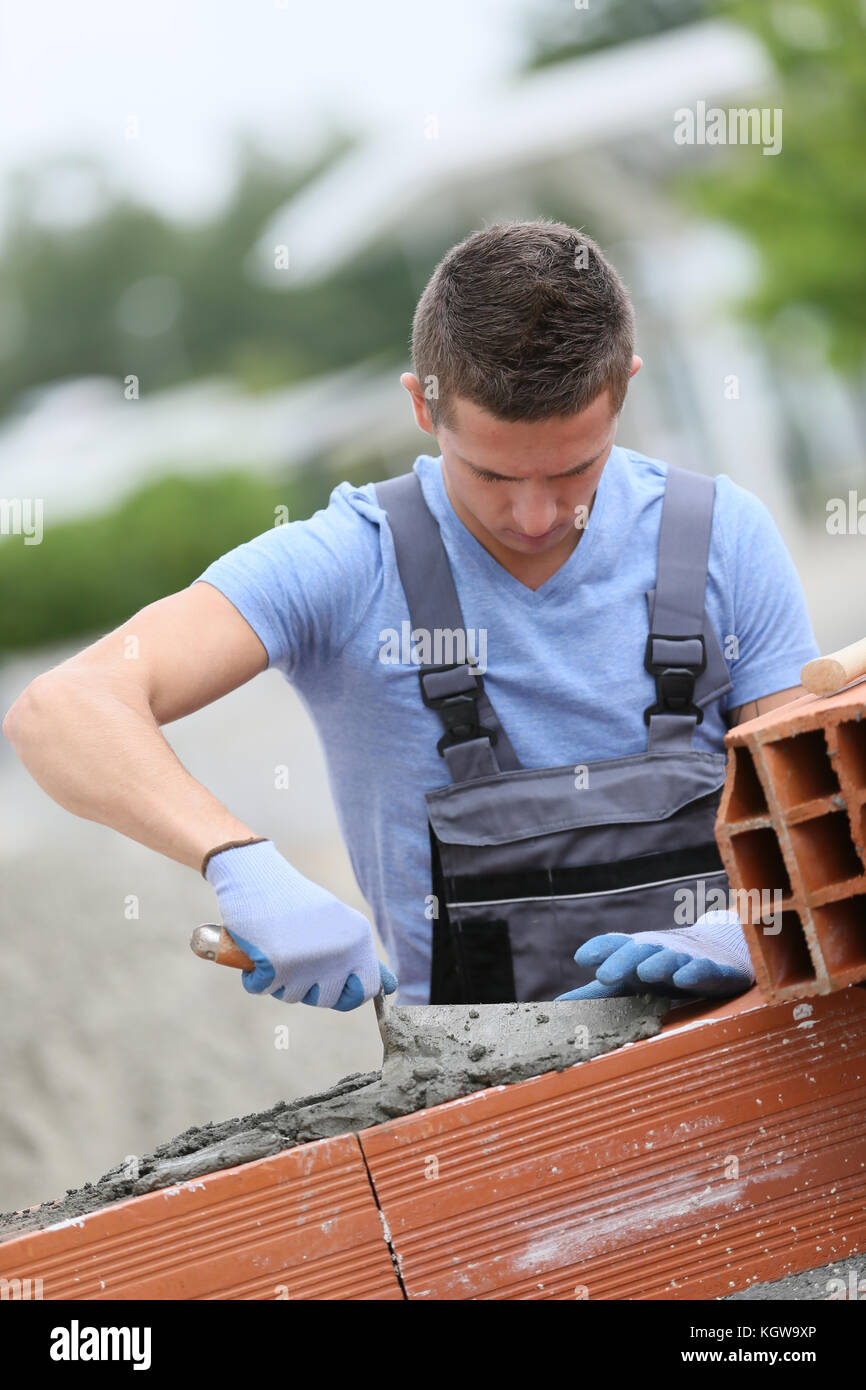 Young brick layer working outside hi-res stock photography and images ...