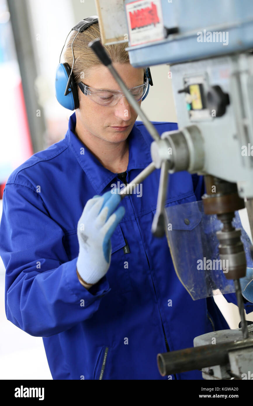 Metalworker making holes in steel tubes with machine Stock Photo - Alamy