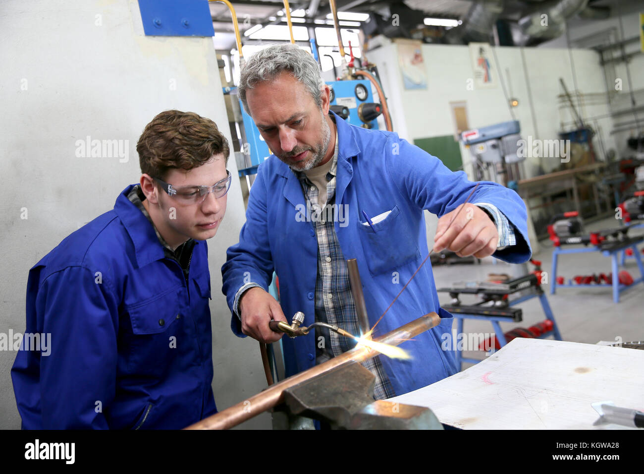 Teacher with student in metallurgy workshop Stock Photo - Alamy
