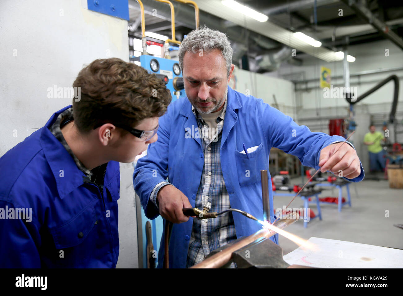 Teacher with student in metallurgy workshop Stock Photo - Alamy