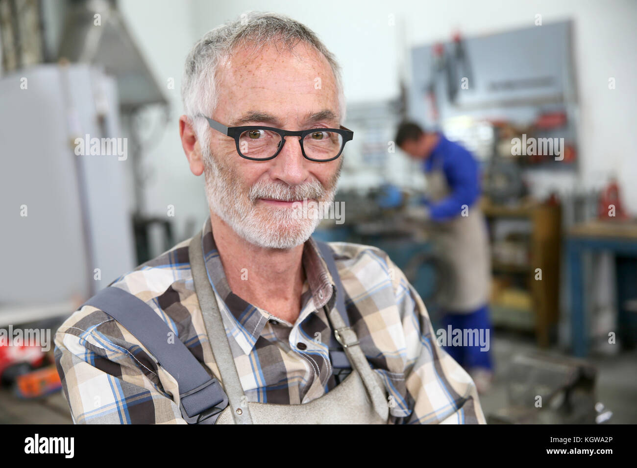 Portrait of smiling senior ironworker Stock Photo - Alamy