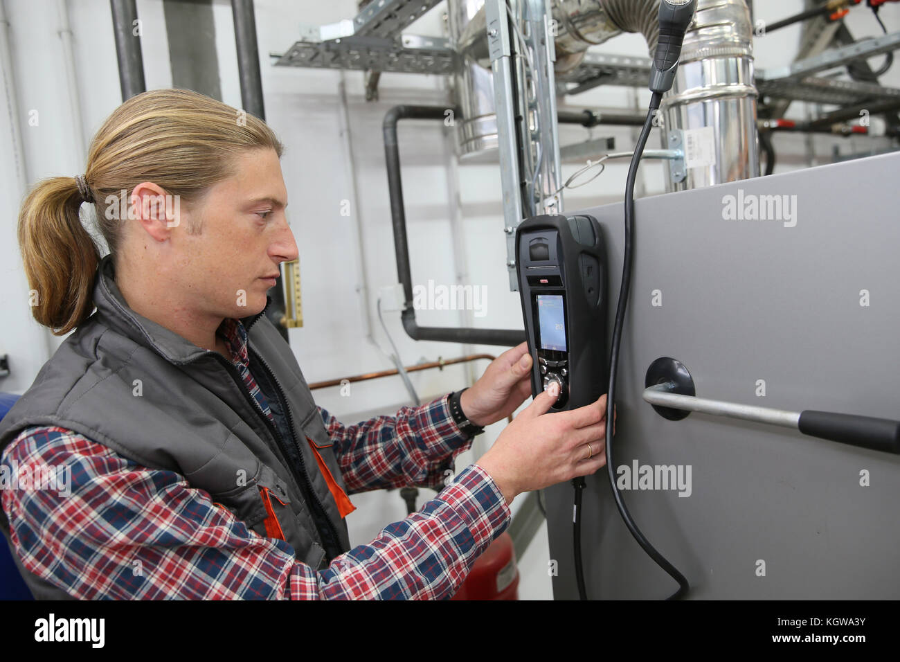 Technician checking heat pump intensity with electronic device Stock ...