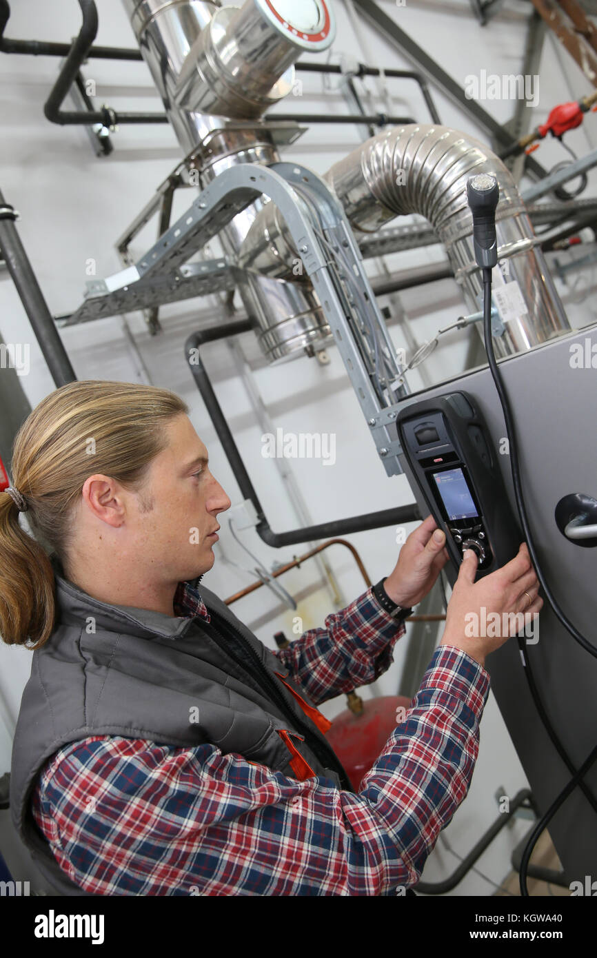 Technician checking heat pump intensity with electronic device Stock ...