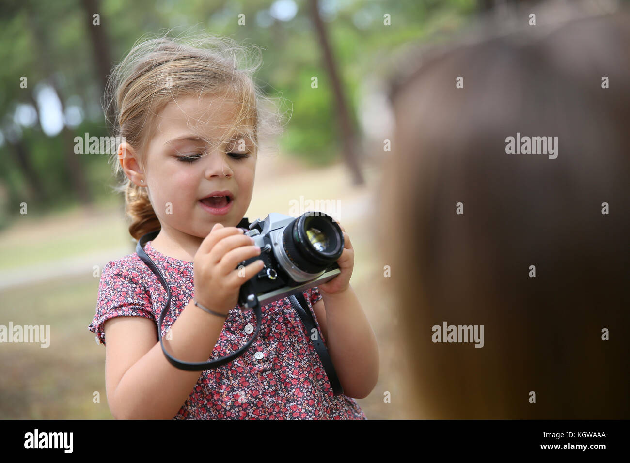 Portrait of little girl taking picture of her parents Stock Photo - Alamy