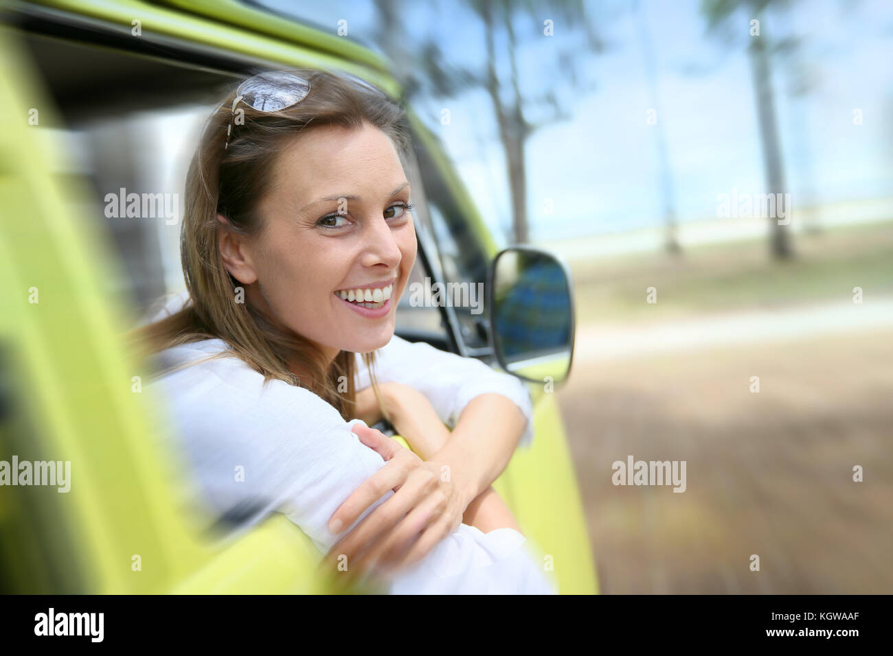 Portrait of cheerful woman sitting in vintage camper van Stock Photo ...