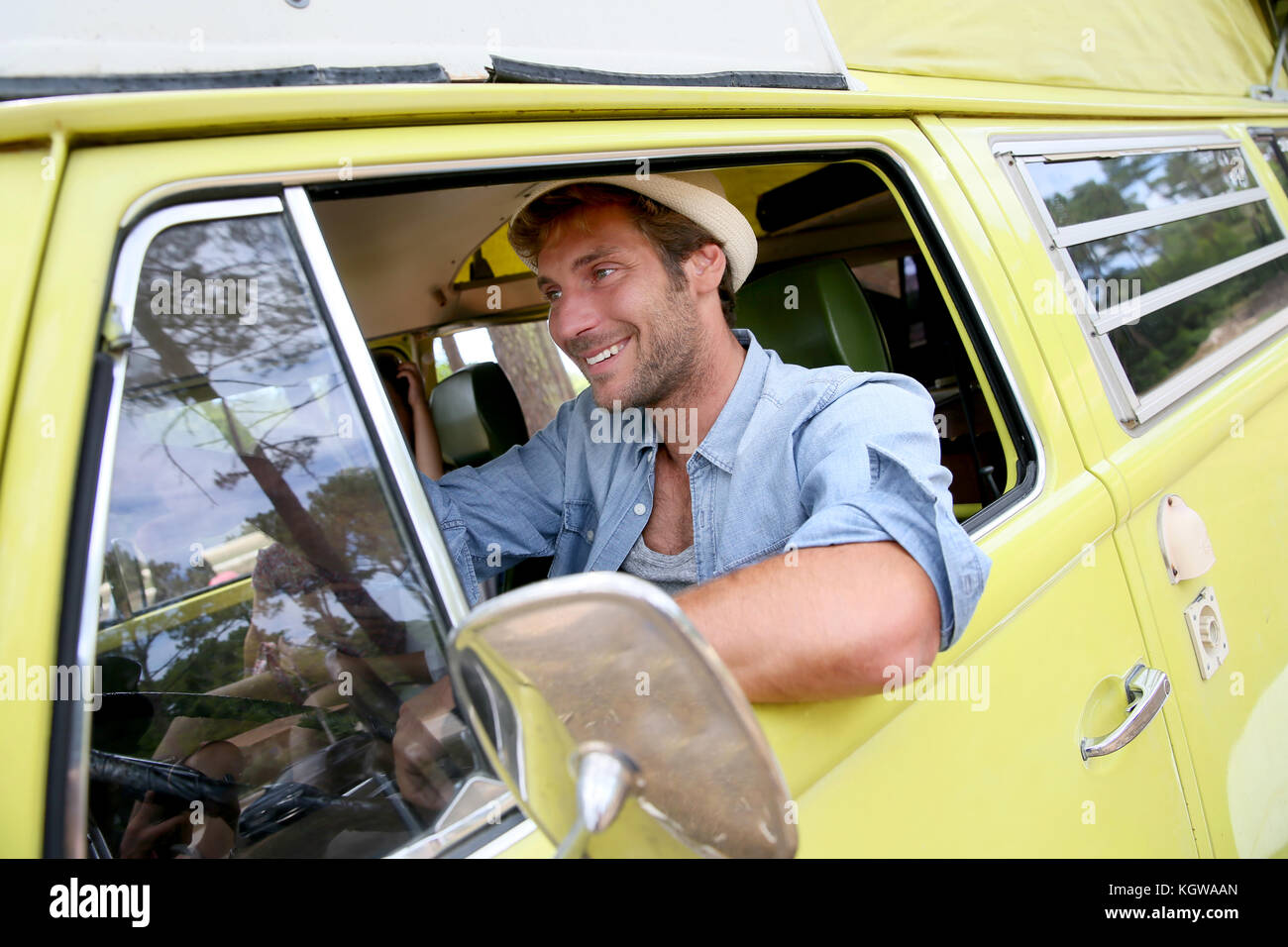 Trendy guy riding a vintage camper van Stock Photo - Alamy
