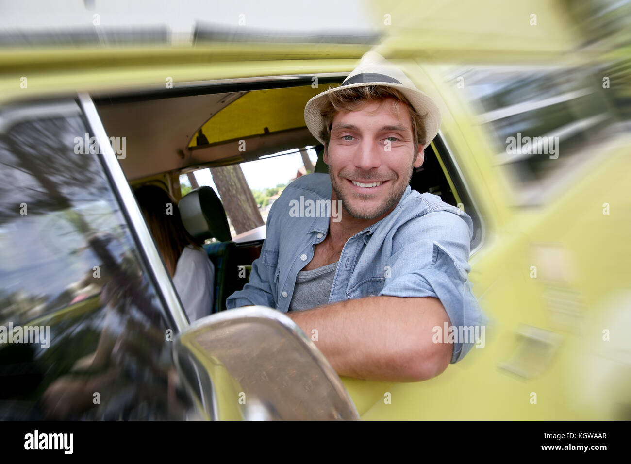 Trendy guy riding a vintage camper van Stock Photo - Alamy