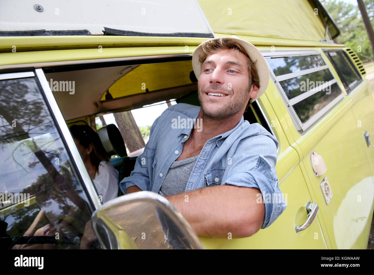 Trendy guy riding a vintage camper van Stock Photo - Alamy