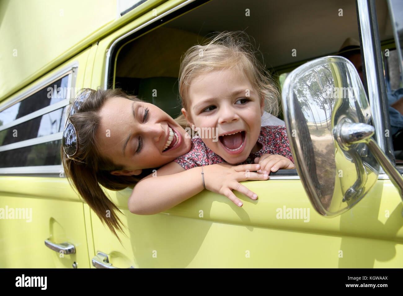 Woman with little girl sitting at camper van window Stock Photo - Alamy