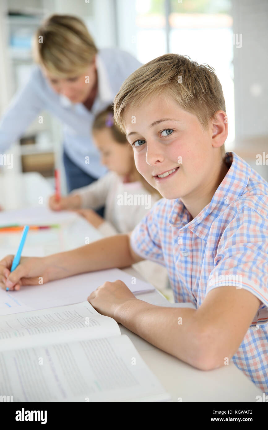 Young smiling schoolboy in classroom Stock Photo - Alamy
