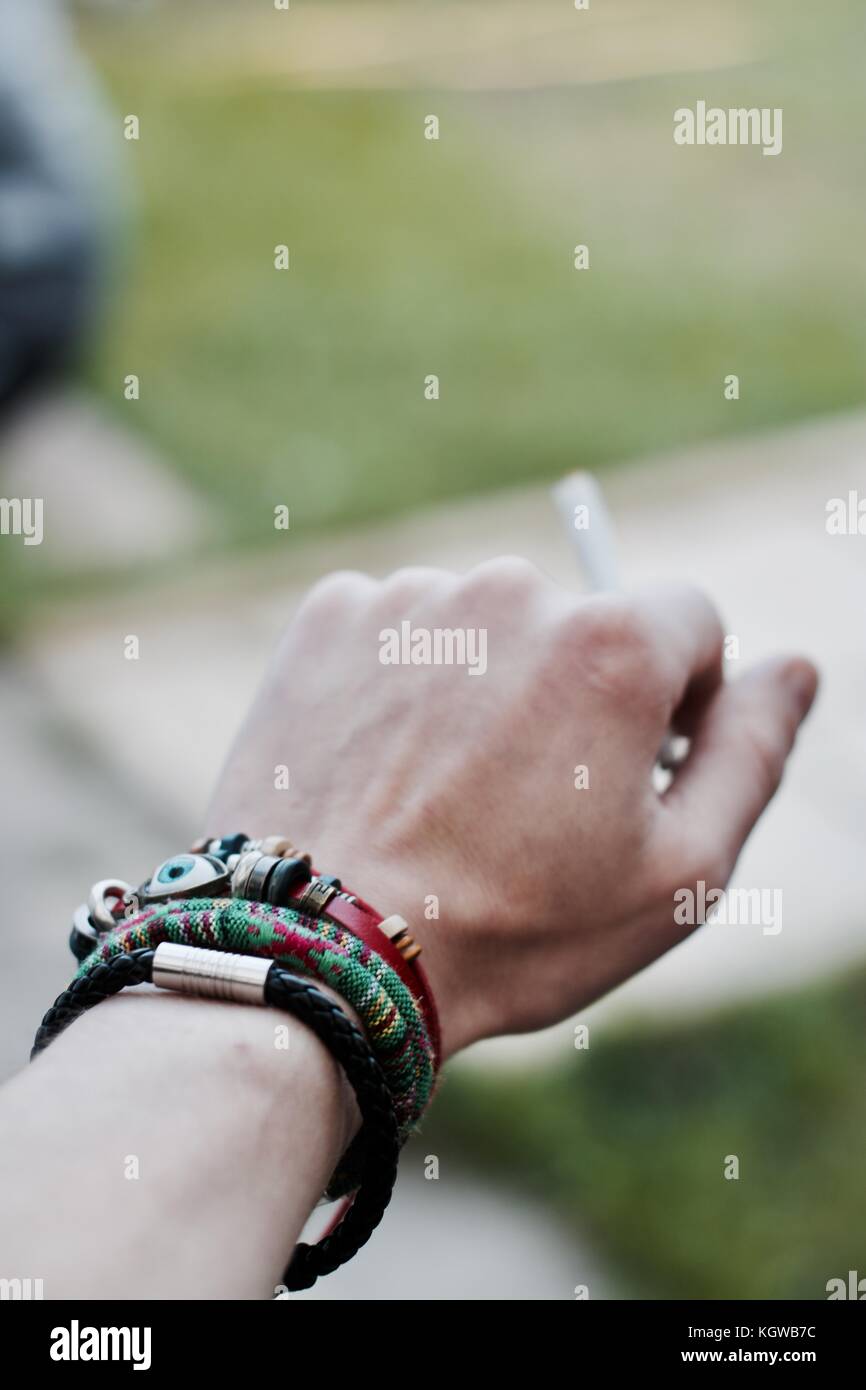 Small spliff in man hand. Marijuana smoking concept Stock Photo - Alamy