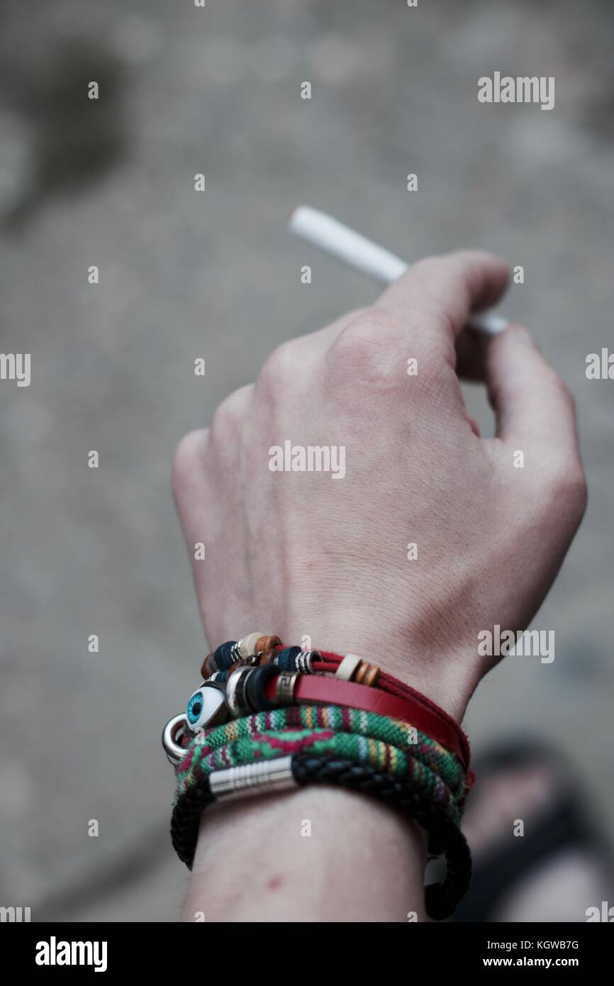 Small spliff in man hand. Marijuana smoking concept Stock Photo - Alamy