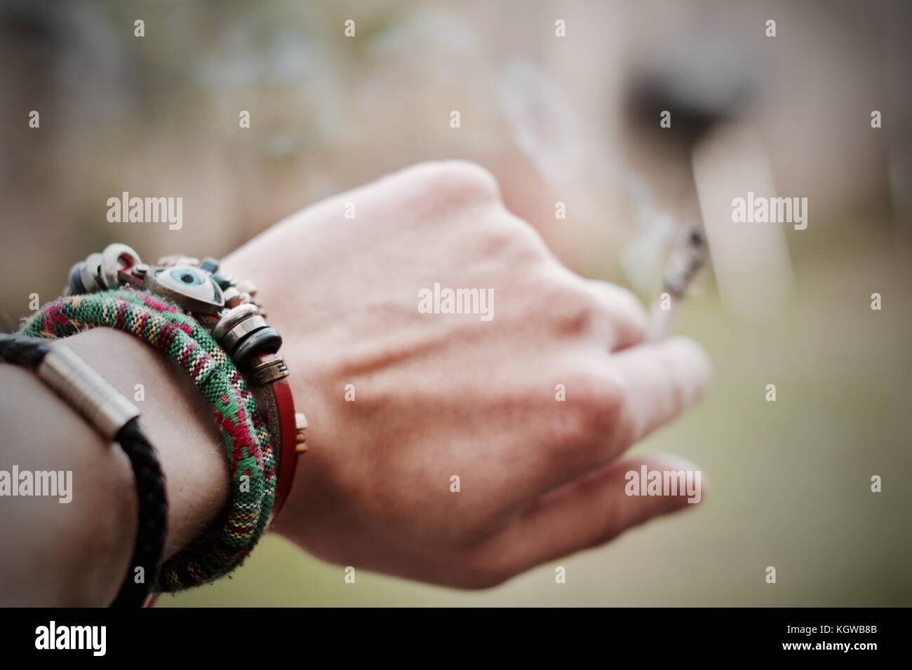 Small spliff in man hand. Marijuana smoking concept Stock Photo - Alamy