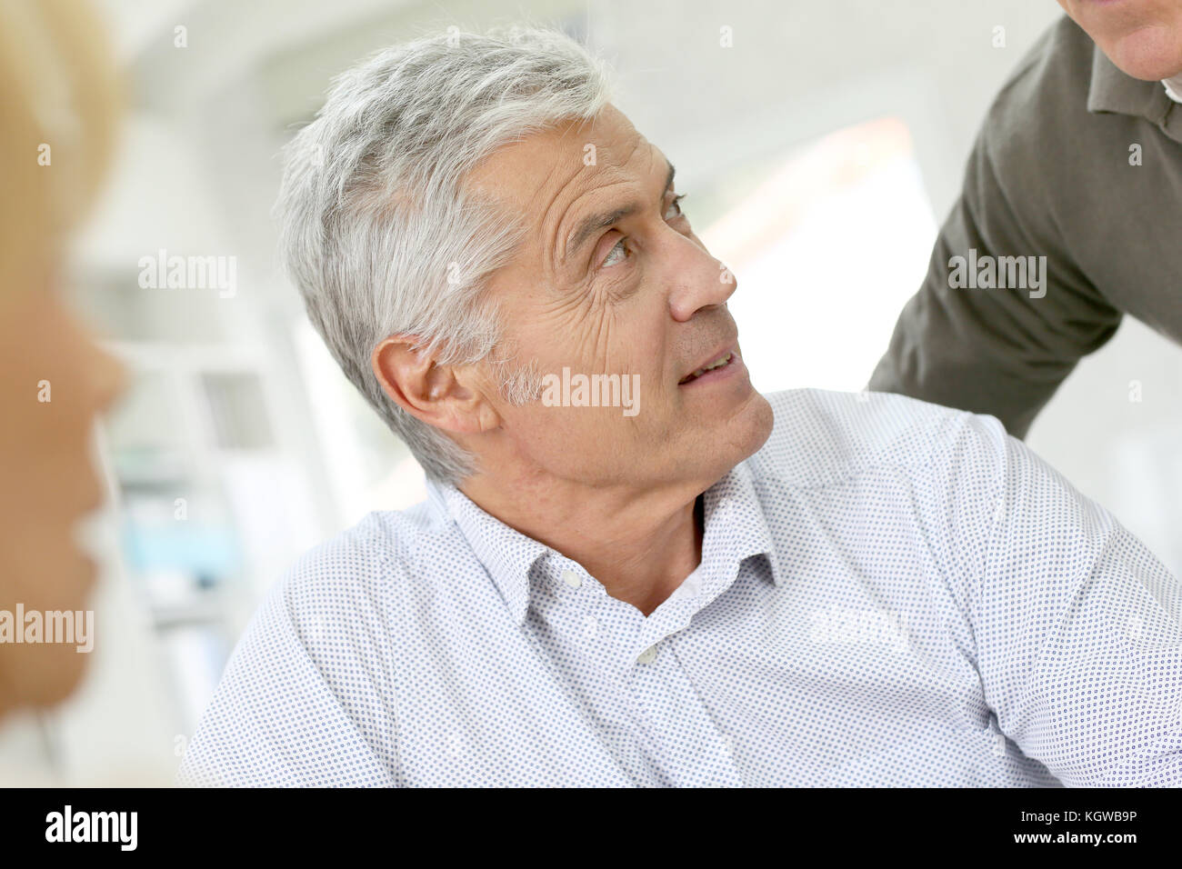Senior man talking to people Stock Photo - Alamy