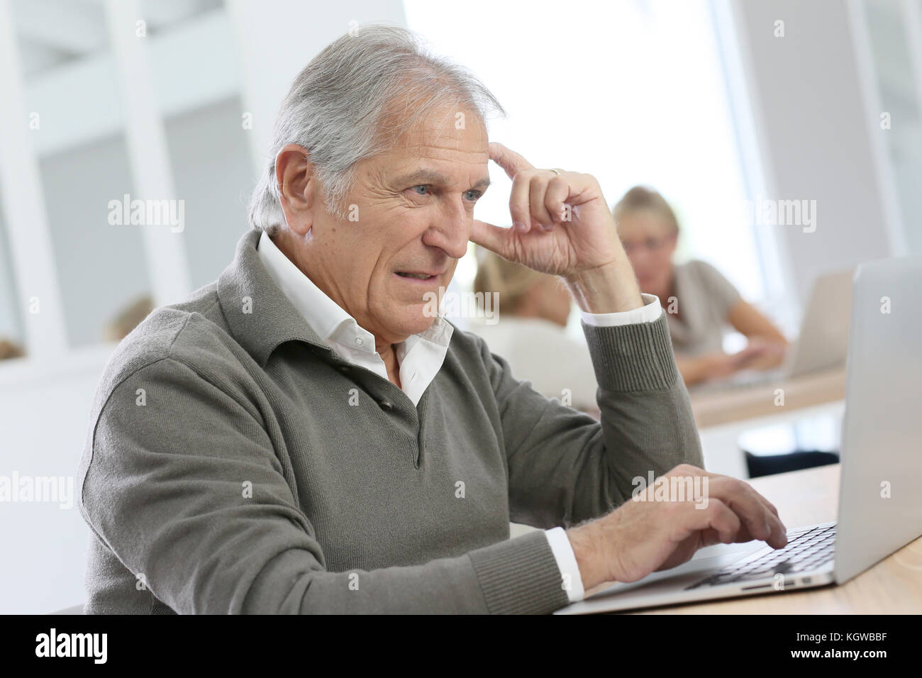 Senior man using laptop computer Stock Photo - Alamy