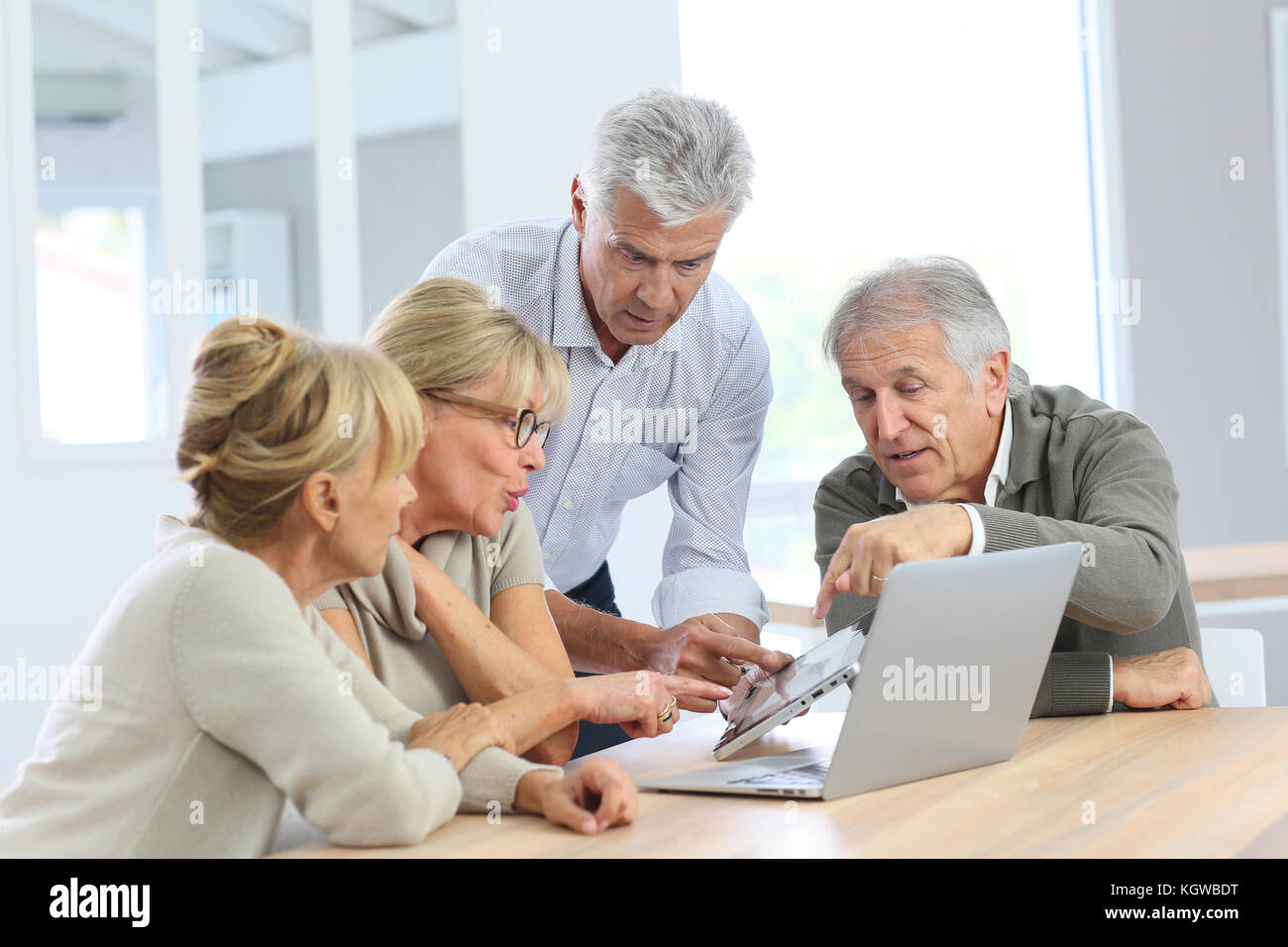 Group of retired senior people using laptop and tablet Stock Photo - Alamy