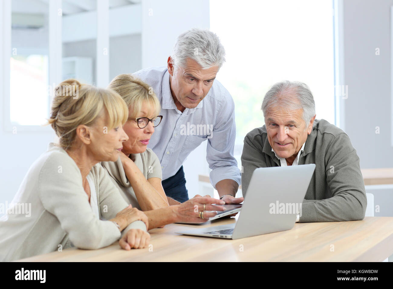 Group of retired senior people using laptop and tablet Stock Photo - Alamy