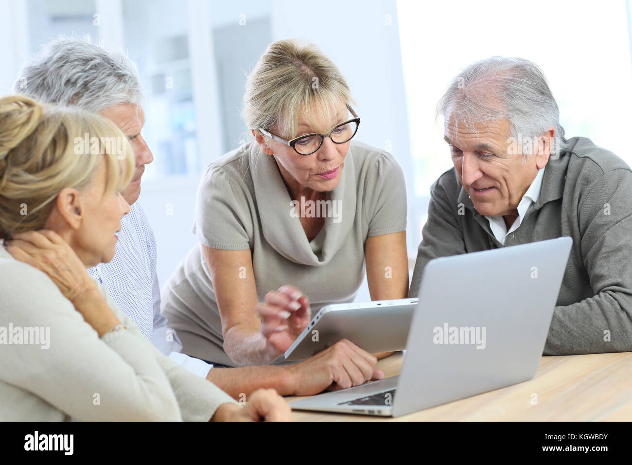 Group of retired senior people using laptop and tablet Stock Photo - Alamy