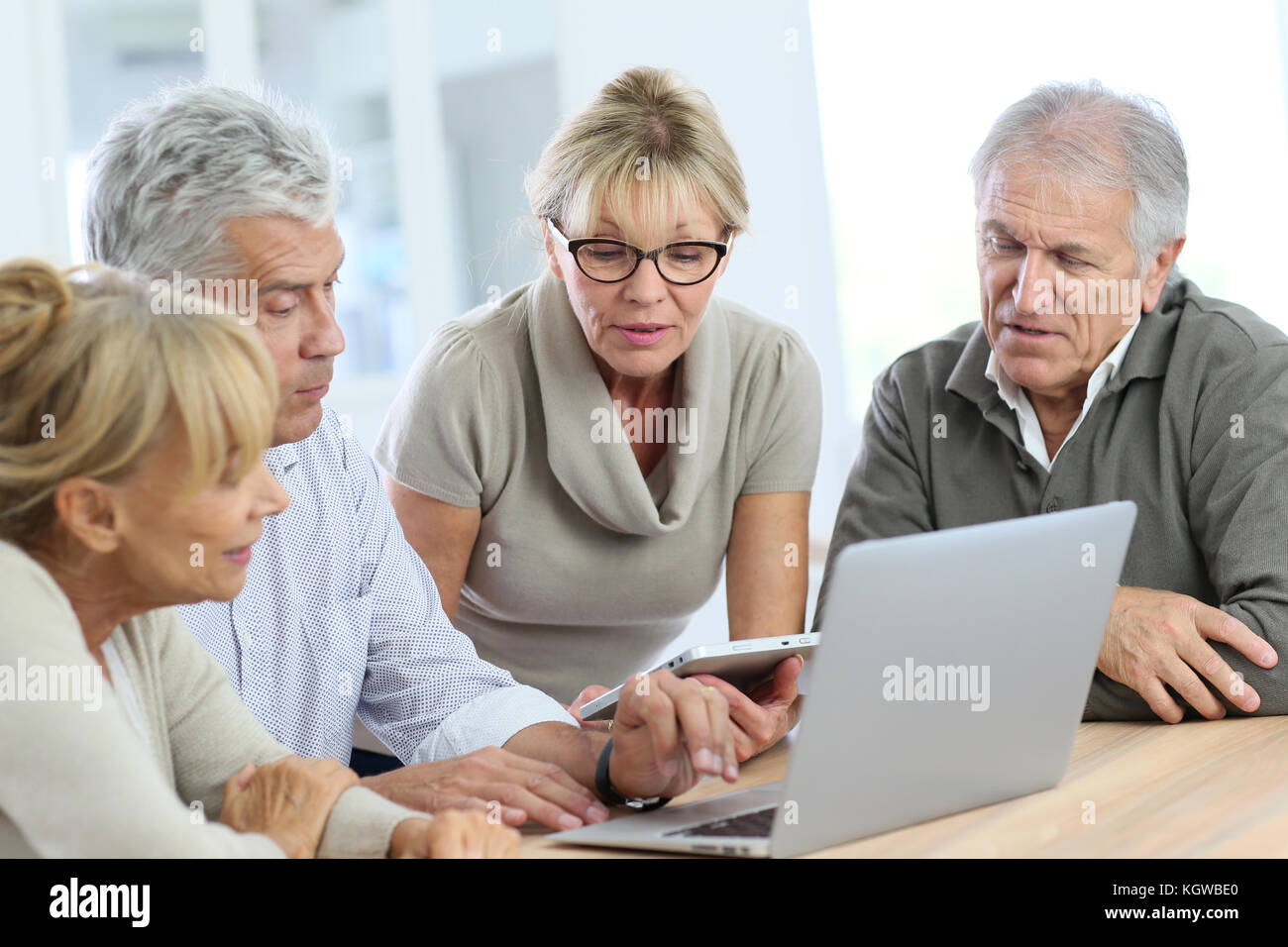 Group of retired senior people using laptop and tablet Stock Photo - Alamy