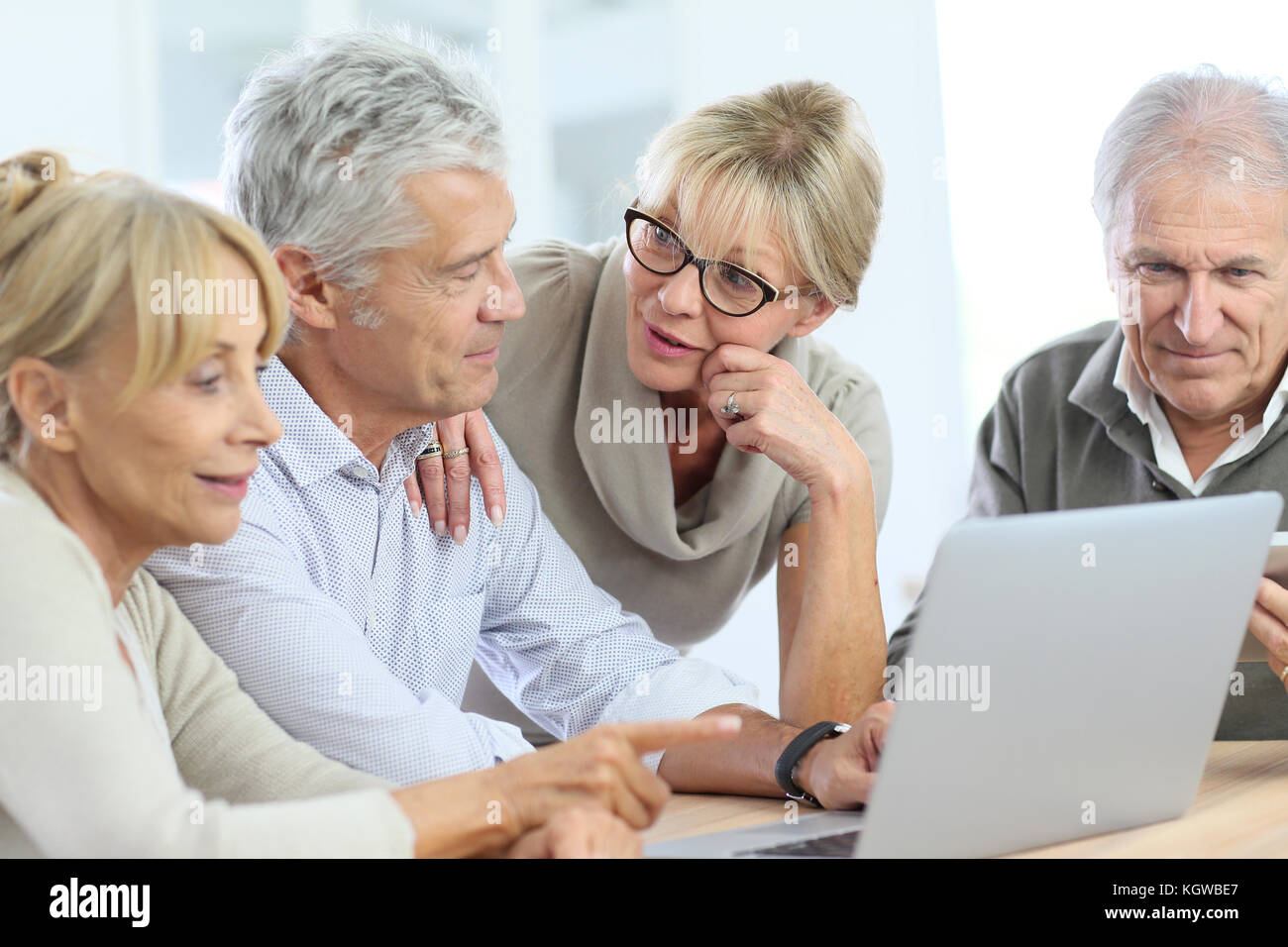 Group of retired senior people using laptop and tablet Stock Photo - Alamy