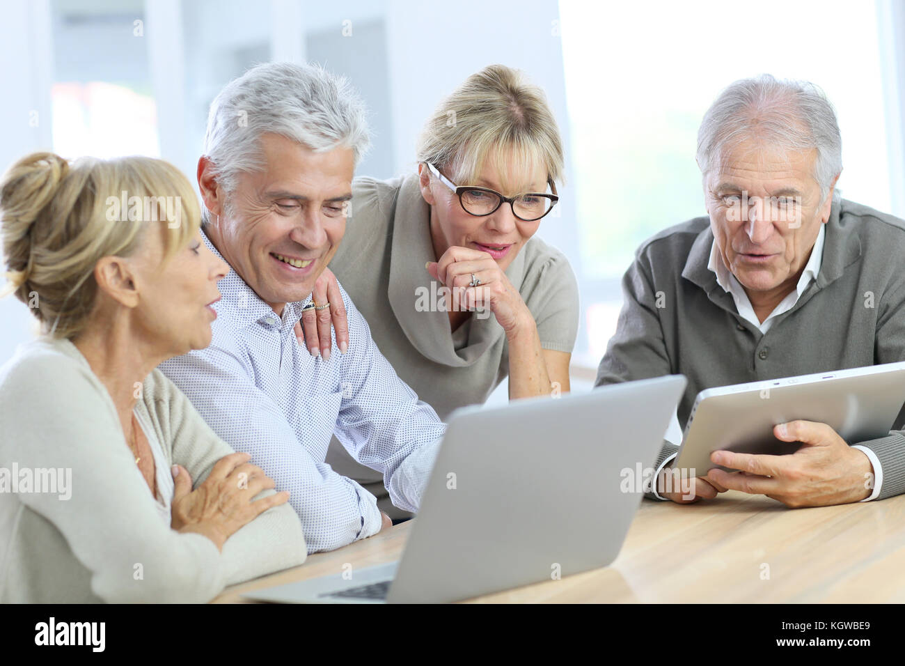 Group of retired senior people using laptop and tablet Stock Photo - Alamy