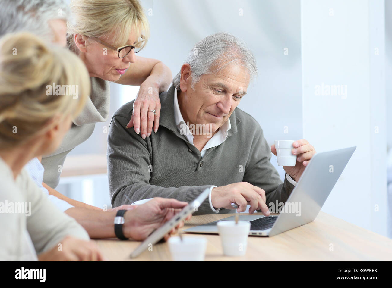Group of retired senior people using laptop and tablet Stock Photo - Alamy
