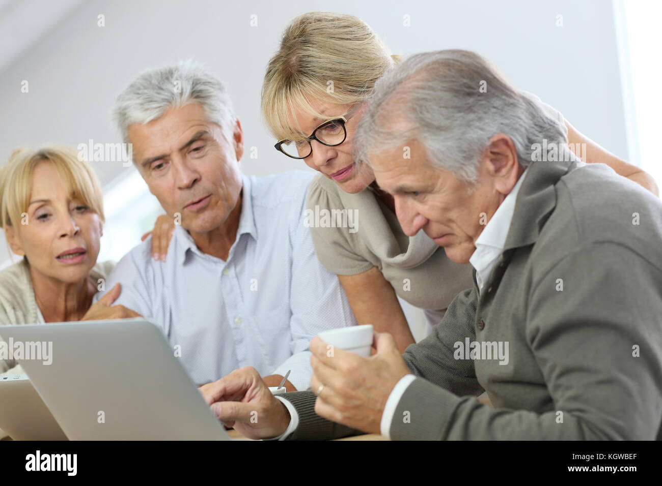 Group of retired senior people using laptop and tablet Stock Photo - Alamy